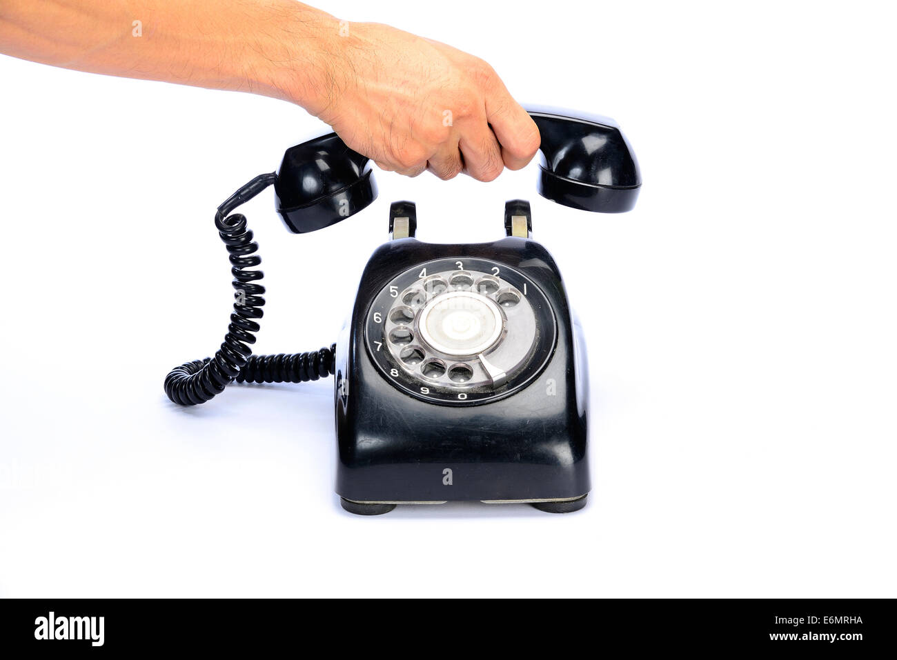 Hand holding an old black telephone isolated on white background Stock ...