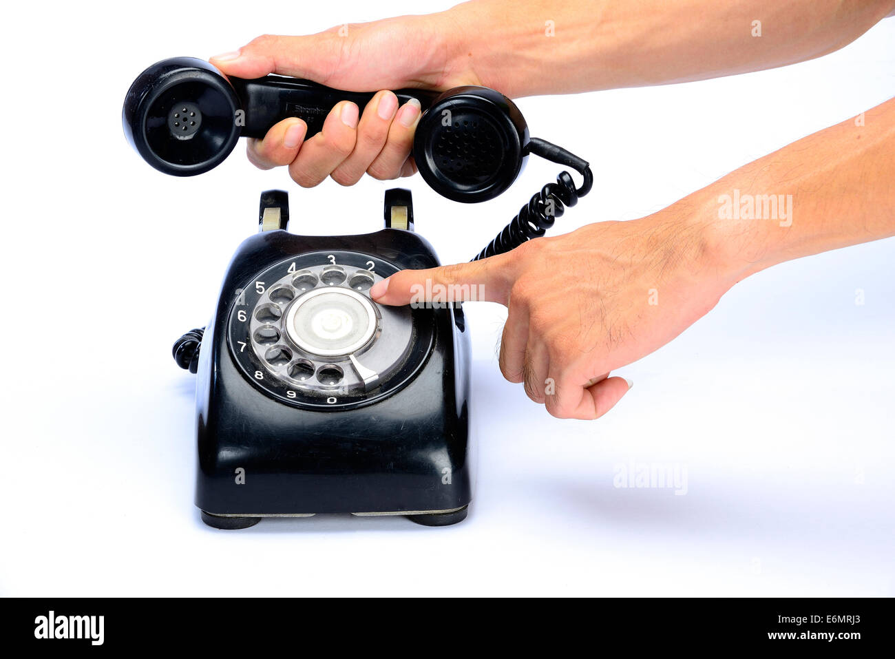 Hand holding an old black telephone isolated on white background Stock ...