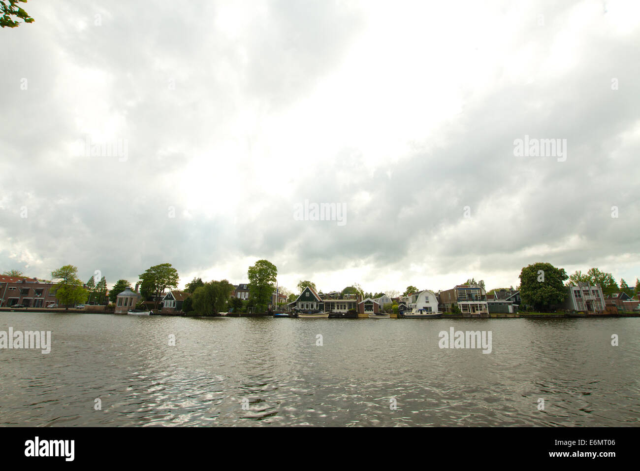 rural dutch scenery of small old houses and canal in Zaanse ...
