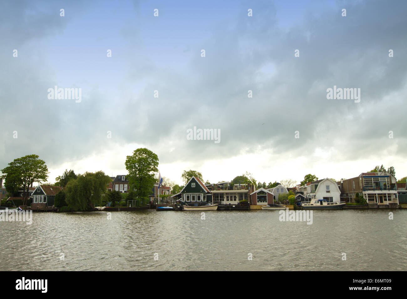rural dutch scenery of small old houses and canal in Zaanse ...