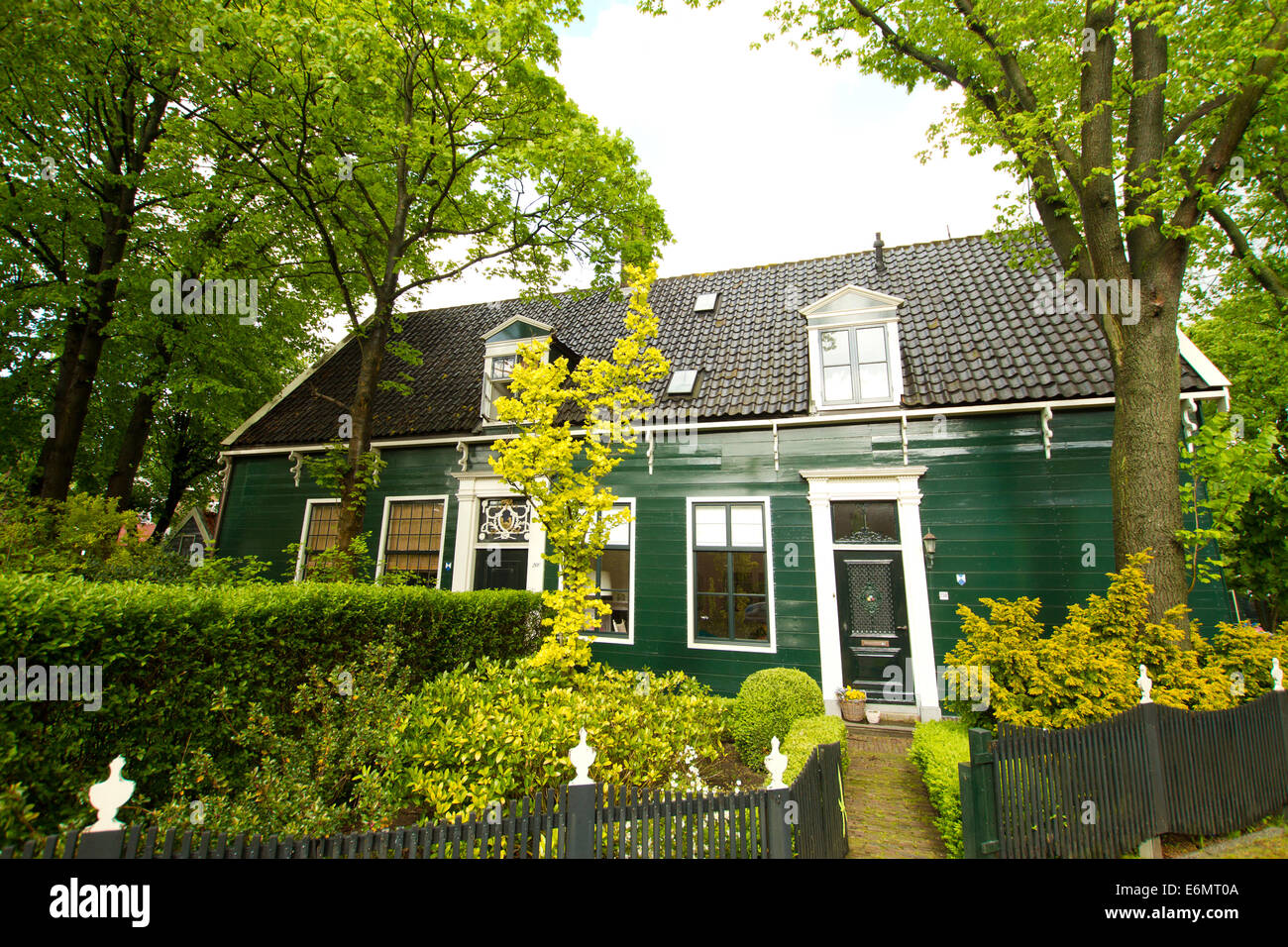 rural dutch scenery of small old houses and canal in Zaanse ...