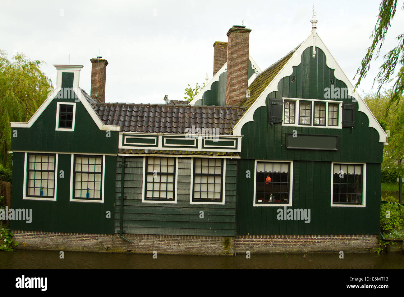 rural dutch scenery of small old houses and canal in Zaanse ...