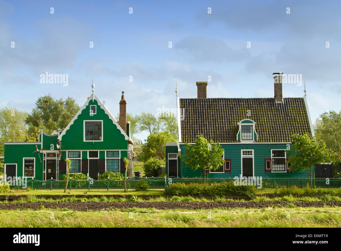 rural dutch scenery of small old houses and canal in Zaanse ...