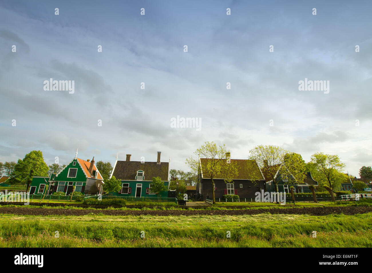 rural dutch scenery of small old houses and canal in Zaanse ...