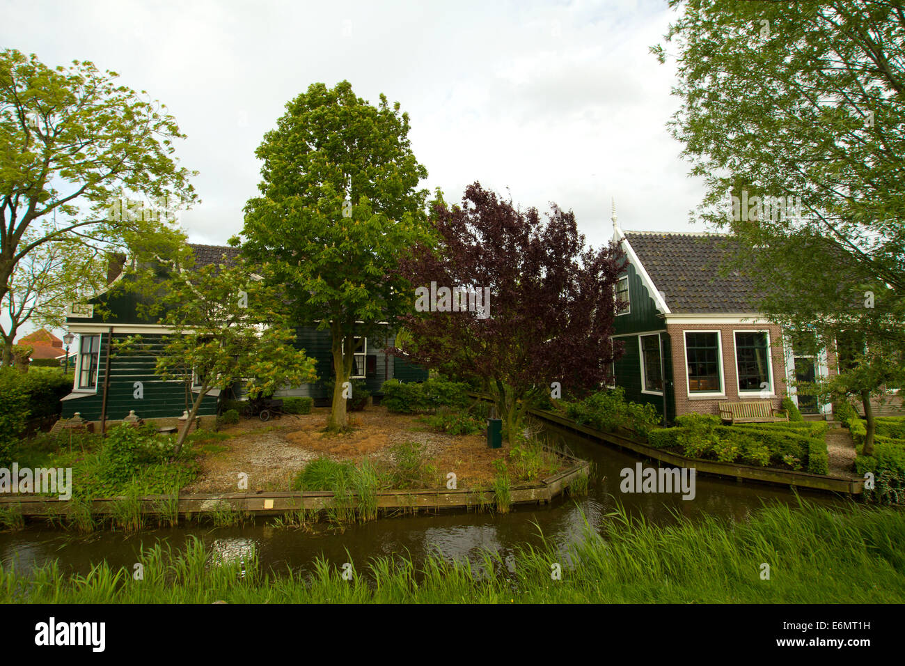 rural dutch scenery of small old houses and canal in Zaanse ...