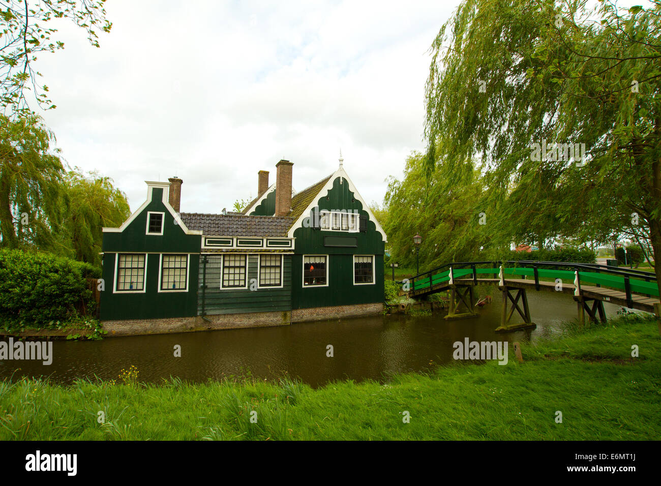 rural dutch scenery of small old houses and canal in Zaanse ...