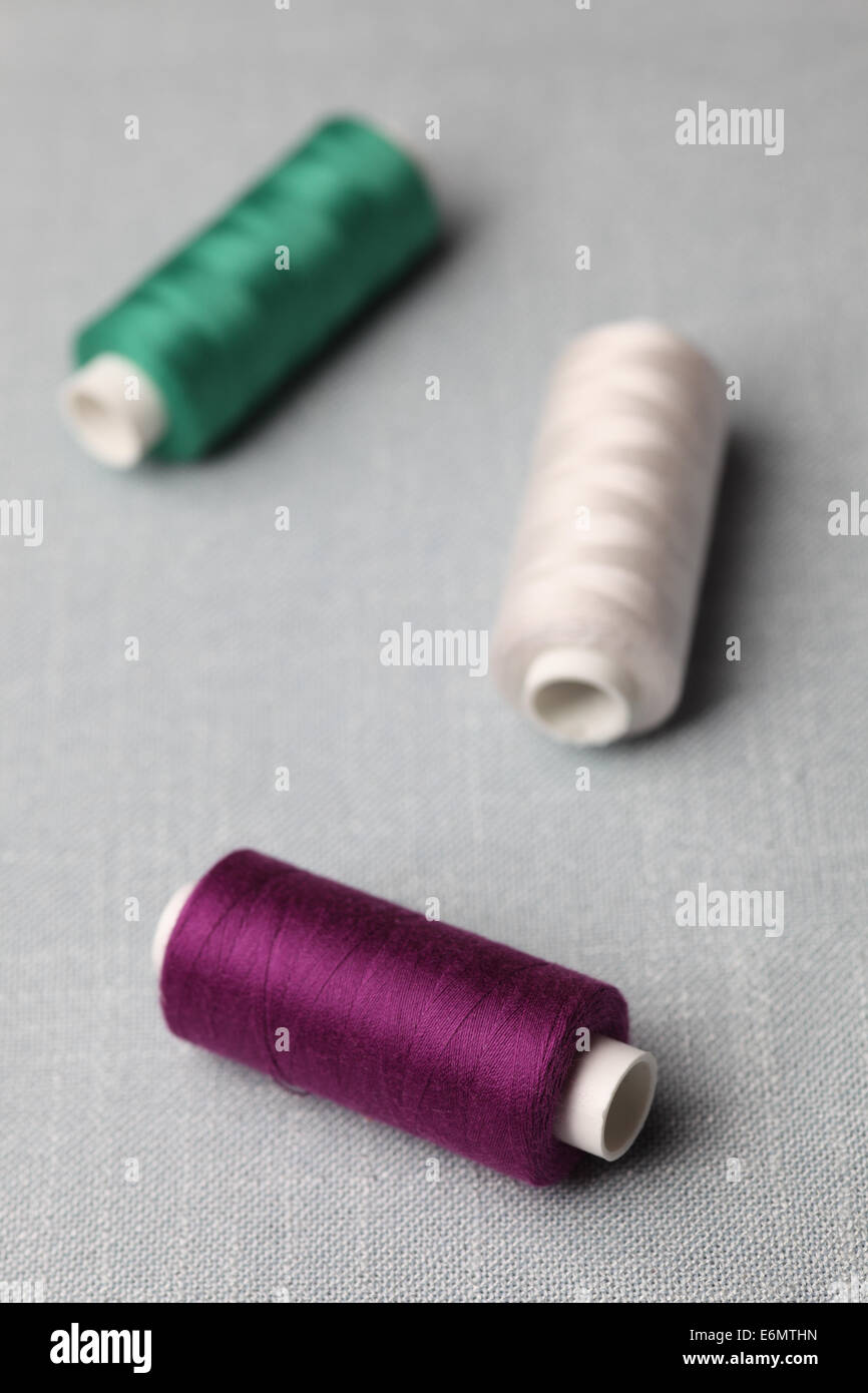 Colorful spools of sewing threads. Closeup Stock Photo - Alamy