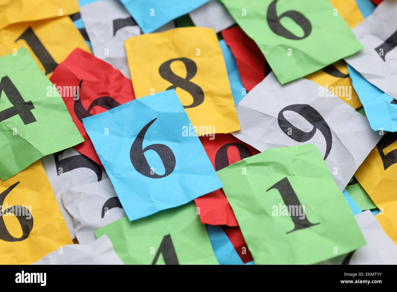 Heap of crumpled colorful paper notes with numbers. Closeup Stock Photo ...