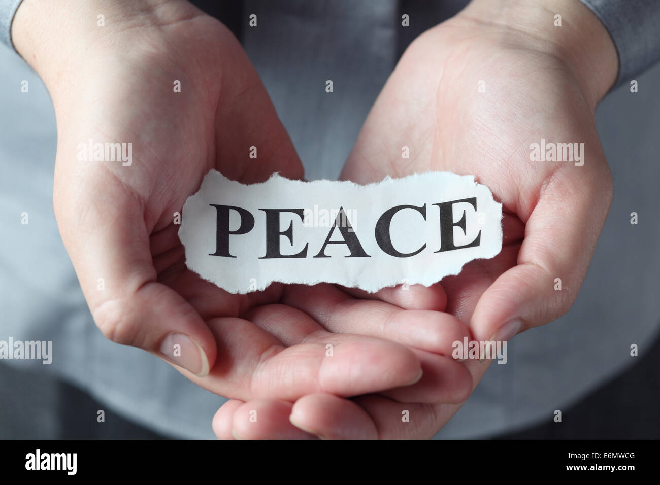 Torn piece of paper with the word "Peace" in the woman's palms Stock ...