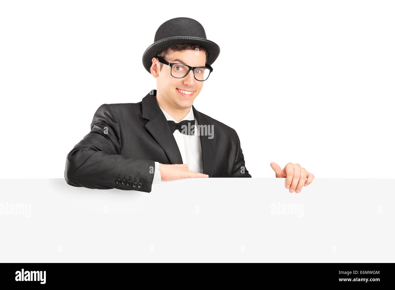 Male performer standing behind a blank panel isolated on white ...