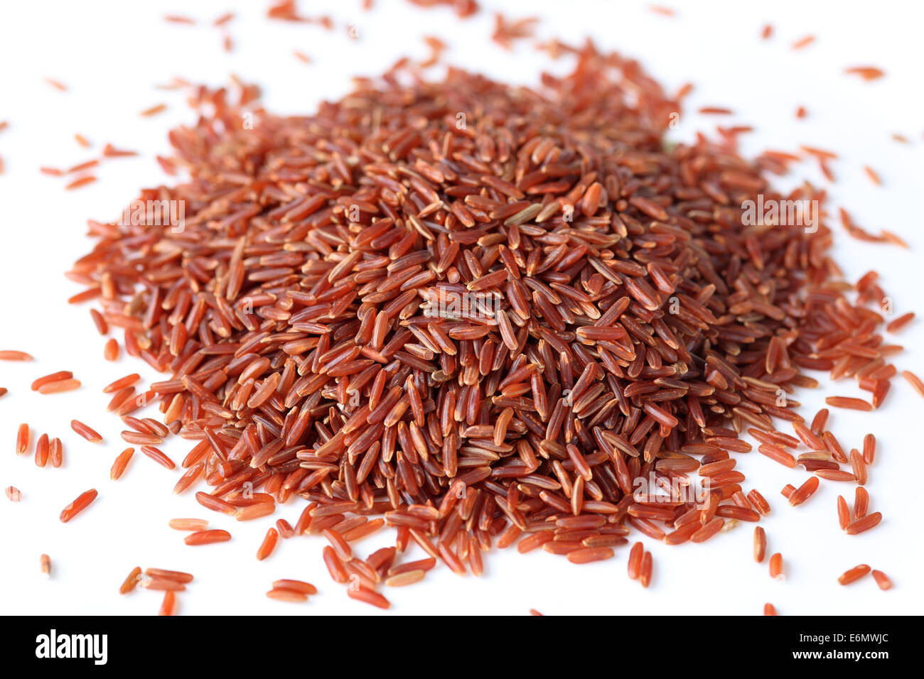 Red rice heap. White background. Close-up Stock Photo - Alamy