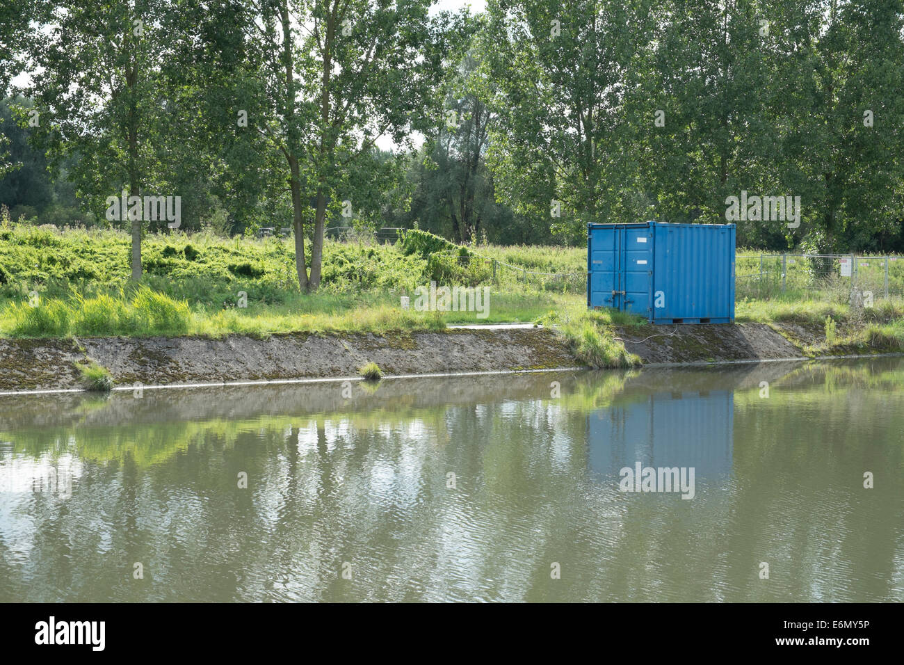 Blue metal container by canal Stock Photo - Alamy