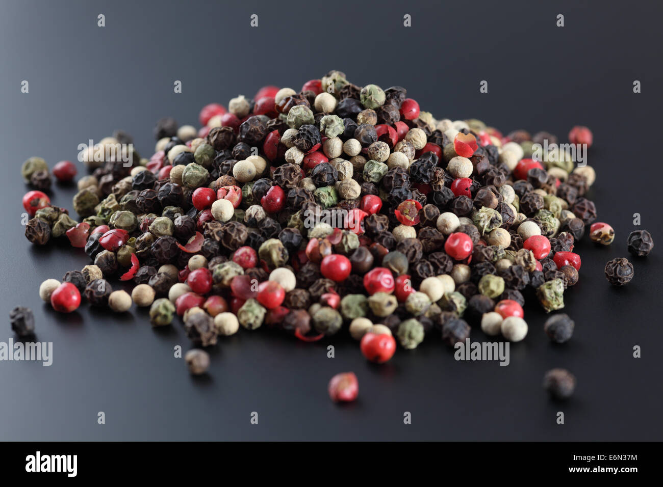 Mixed peppercorns on black background Stock Photo - Alamy