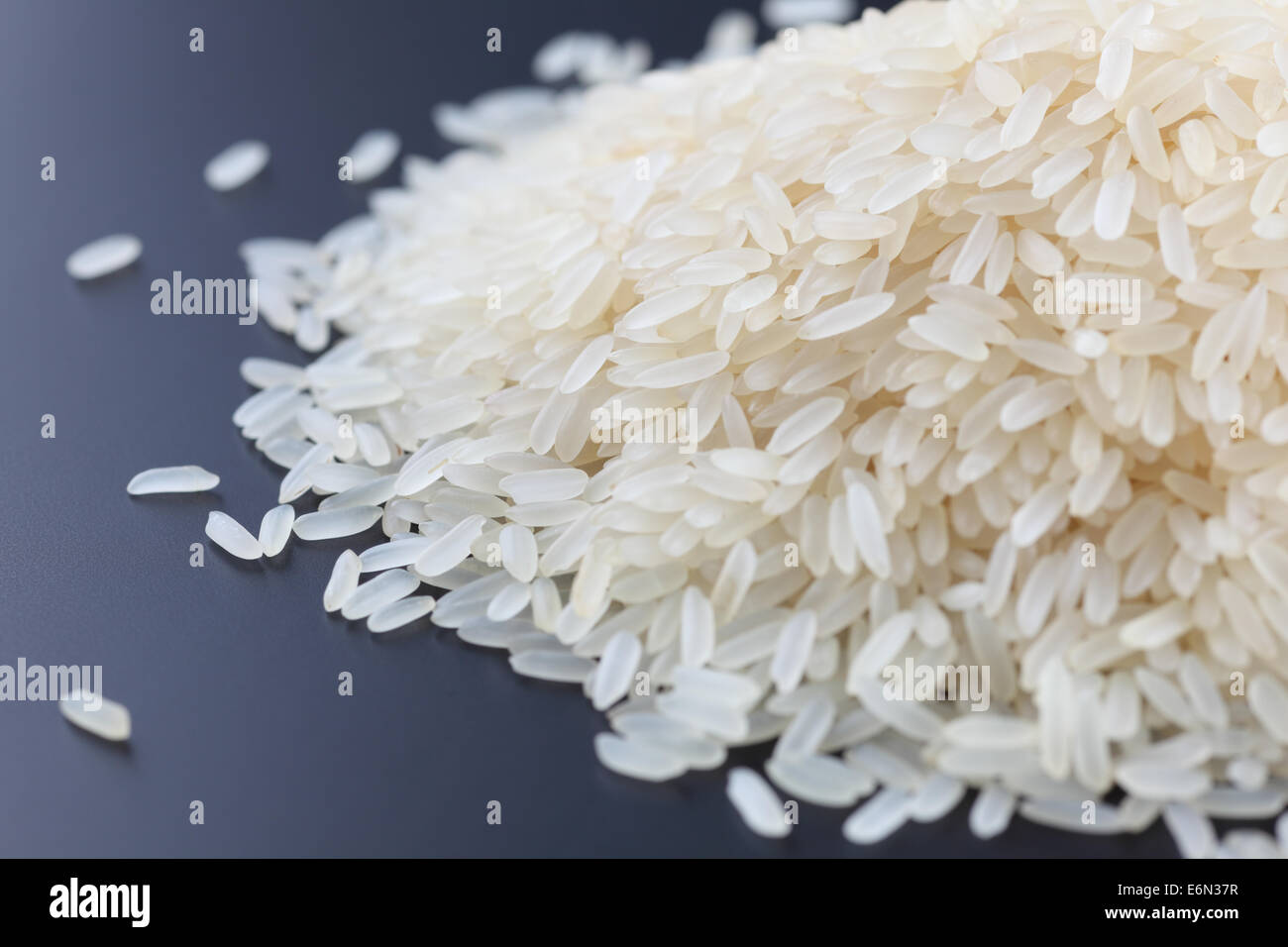 Rice heap on a black background Stock Photo - Alamy
