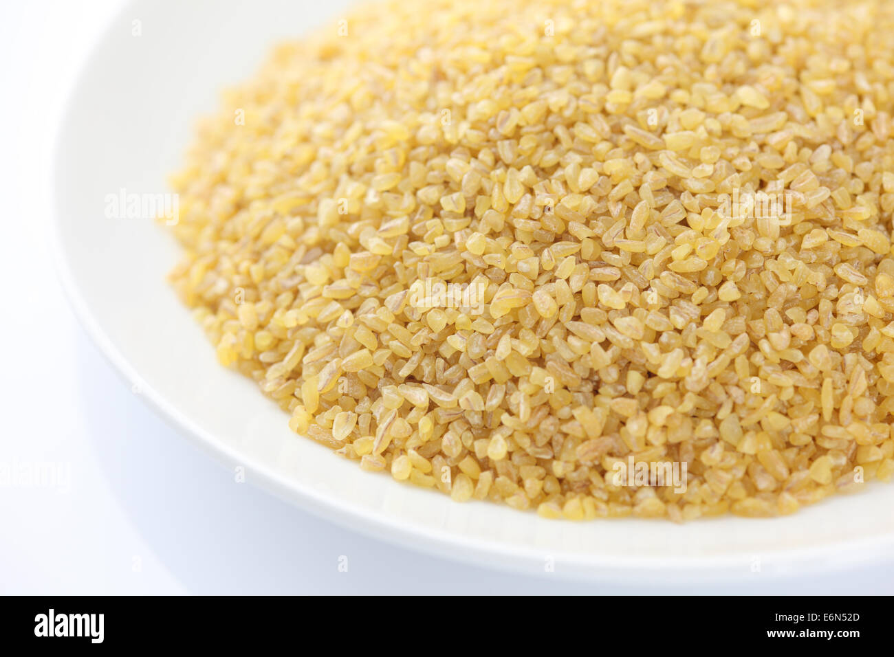 Bulgur wheat in a plate is on white background Stock Photo - Alamy