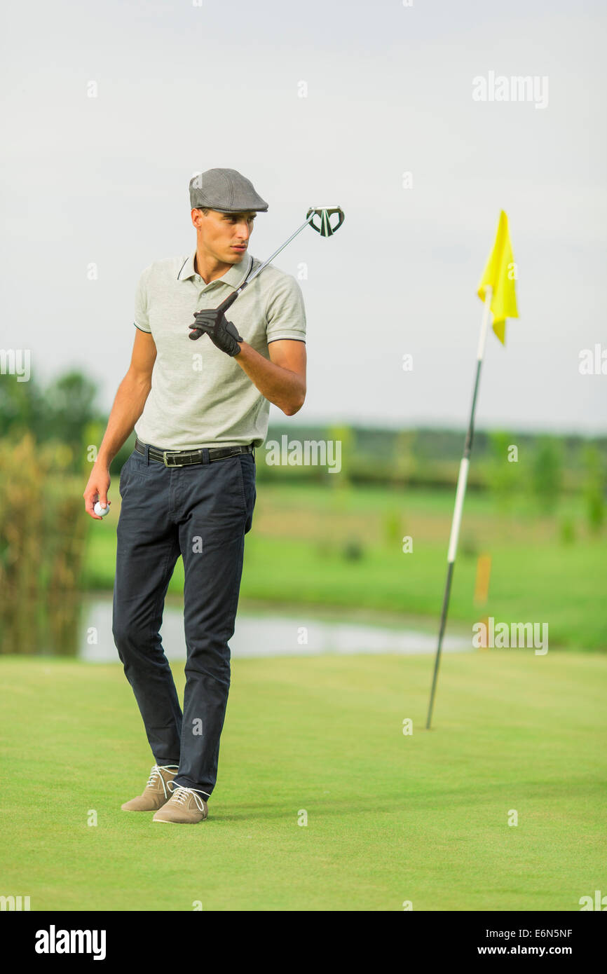 Young man playing golf Stock Photo - Alamy