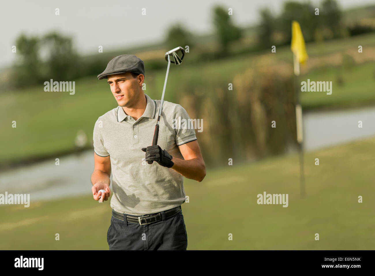 Young man playing golf Stock Photo - Alamy