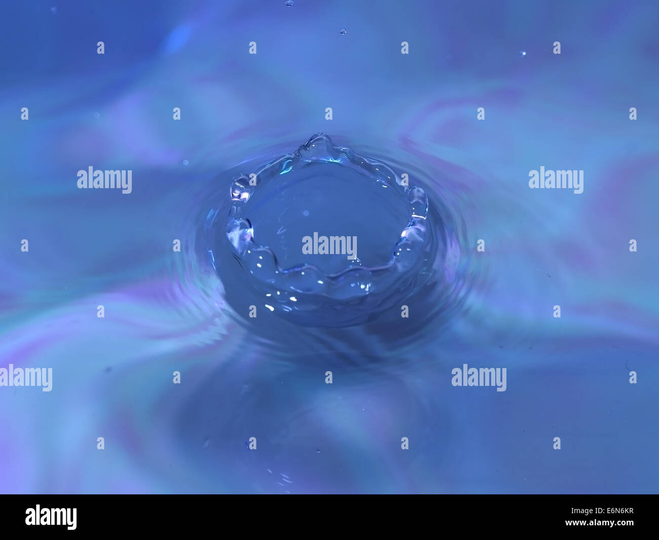 Water splash with a drop of water flying from above Stock Photo - Alamy