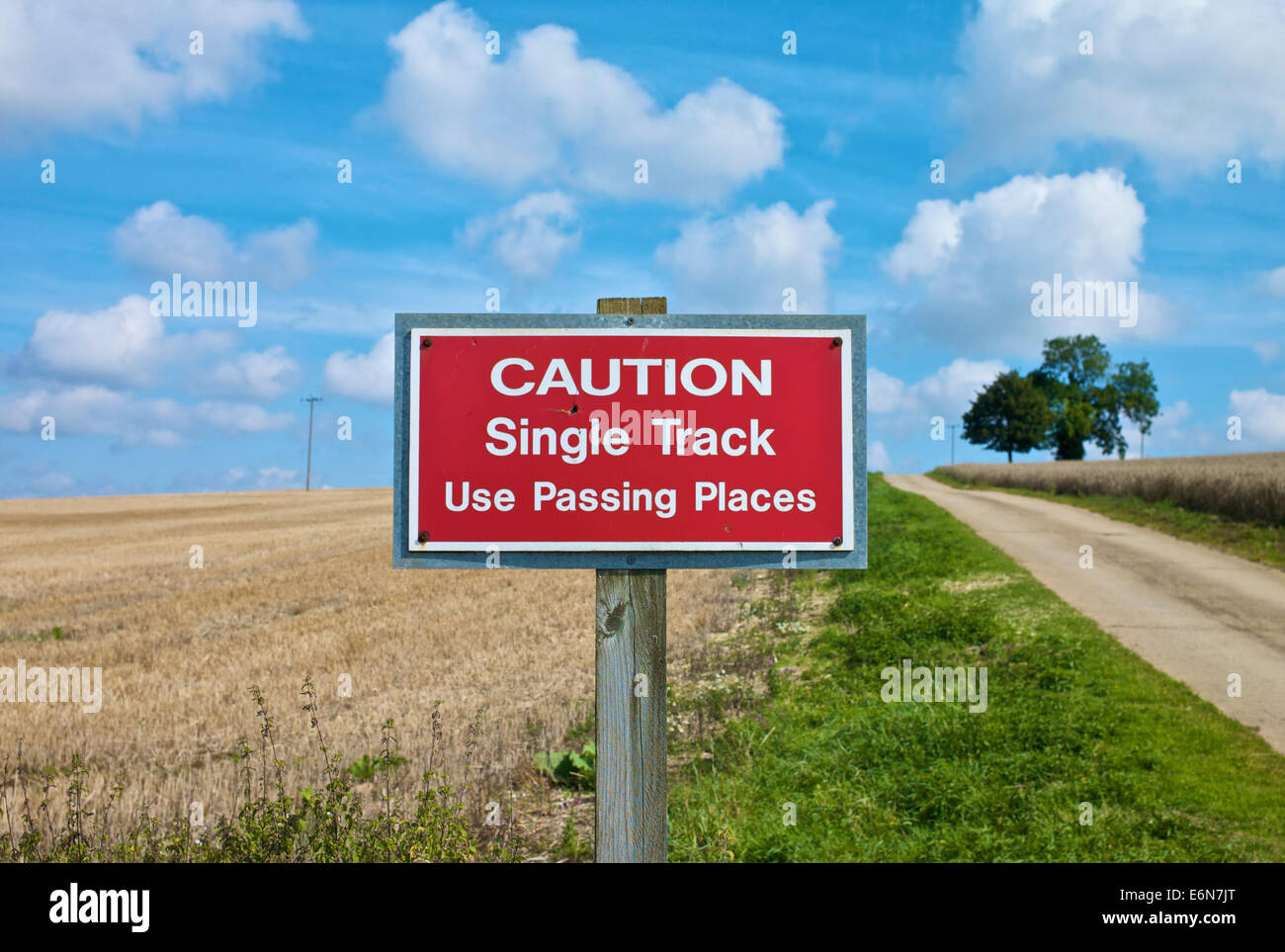 Red sign against blue sky background. Caution Single Track - Use ...