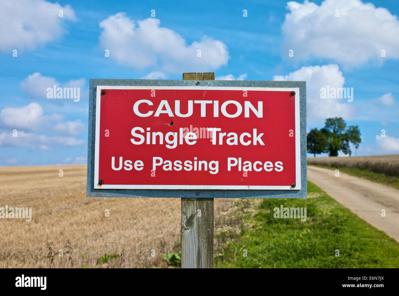 Red sign against blue sky background. Caution Single Track - Use ...