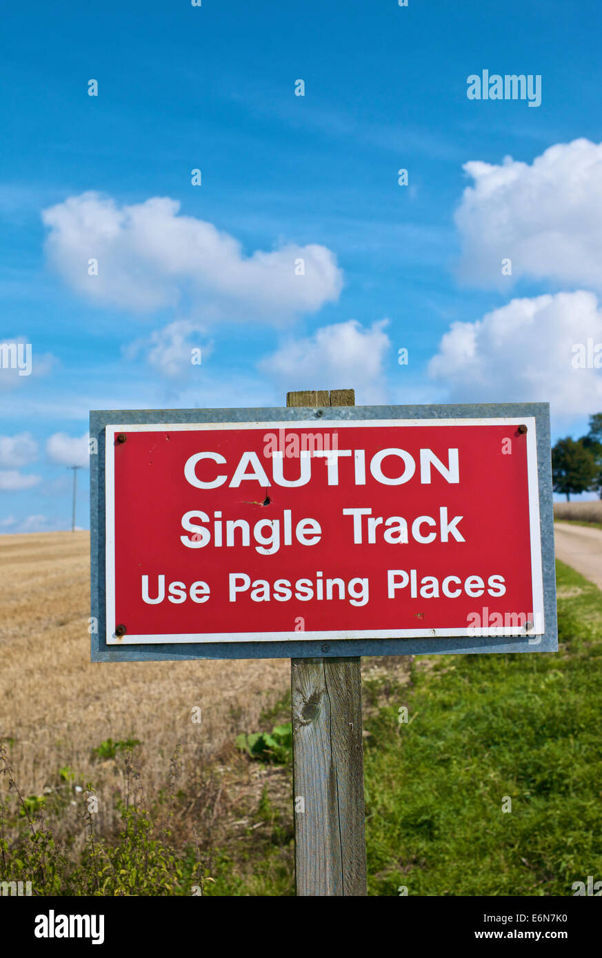 Red sign against blue sky background. Caution Single Track - Use ...