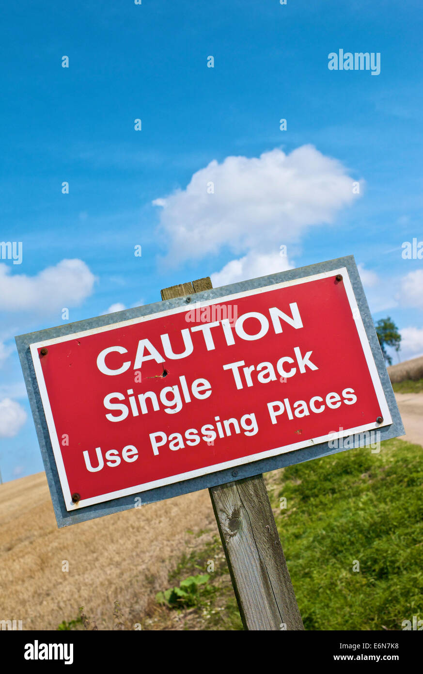 Red sign against blue sky background. Caution Single Track - Use ...