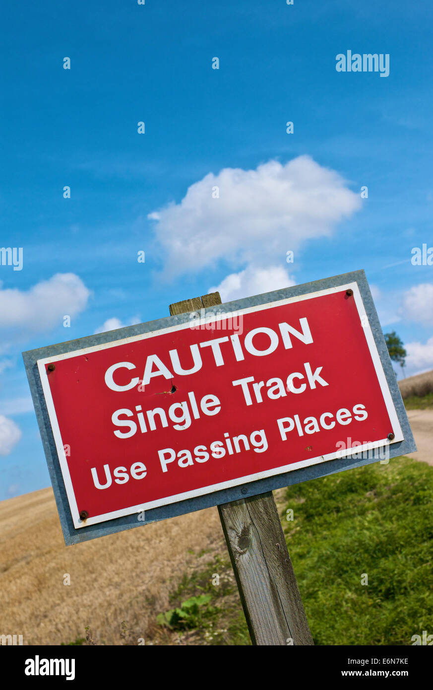 Red sign against blue sky background. Caution Single Track - Use ...