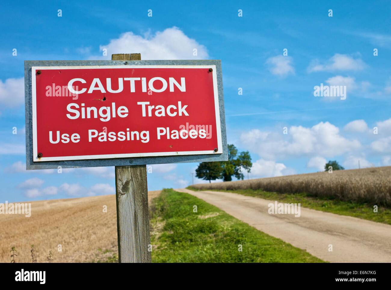 Red sign against blue sky background. Caution Single Track - Use ...