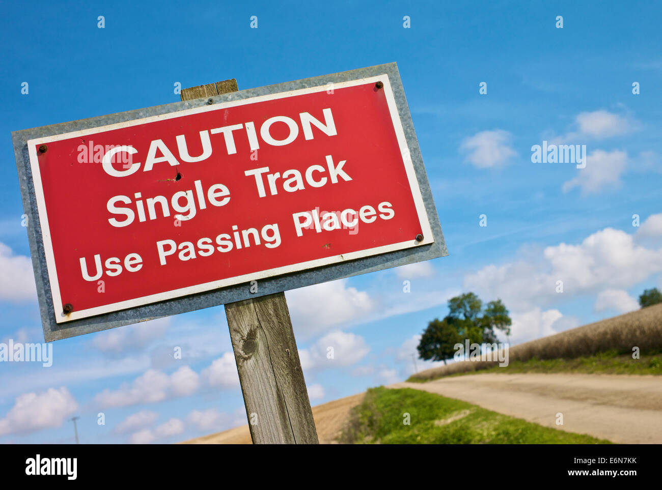 Red sign against blue sky background. Caution Single Track - Use ...