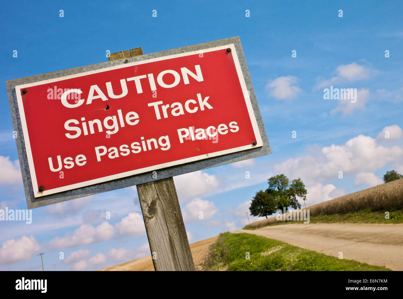 Red sign against blue sky background. Caution Single Track - Use ...