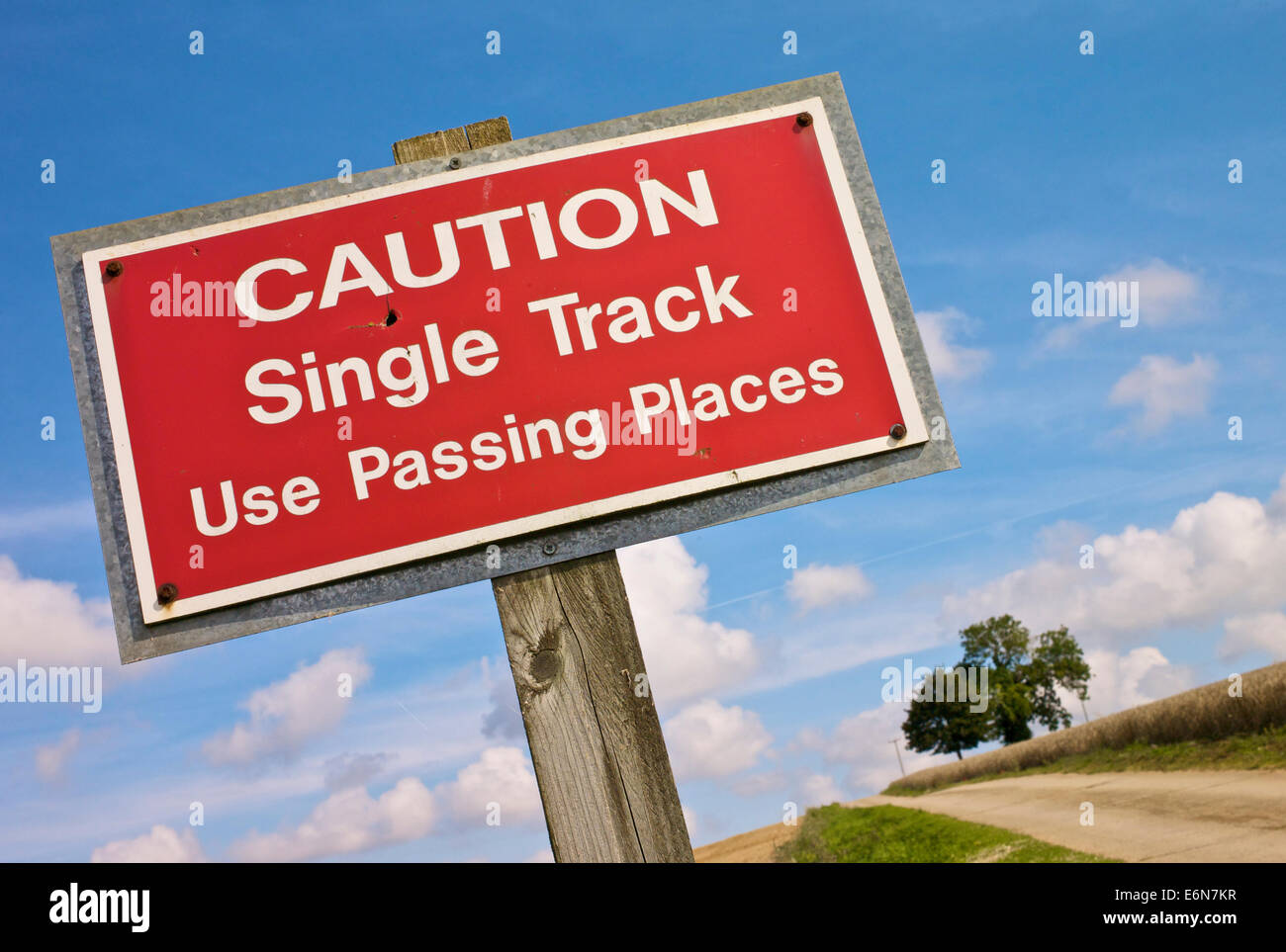 Red sign against blue sky background. Caution Single Track - Use ...