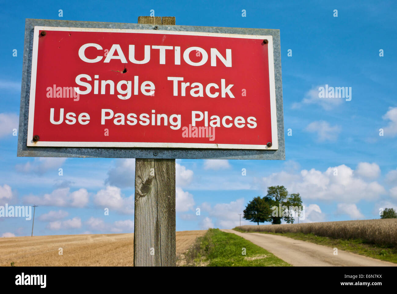 Red sign against blue sky background. Caution Single Track - Use ...