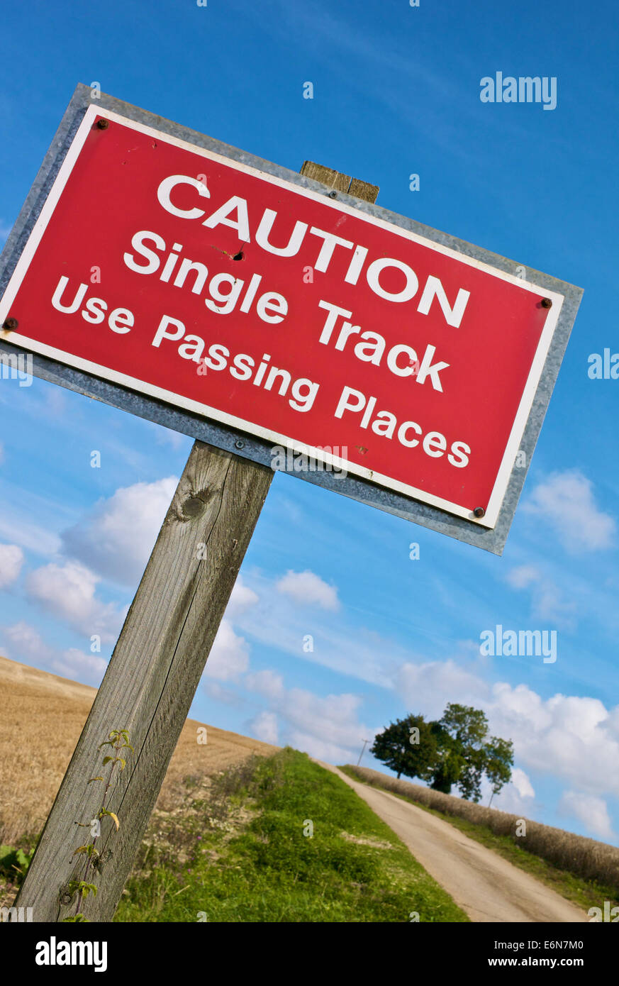 Red sign against blue sky background. Caution Single Track - Use ...