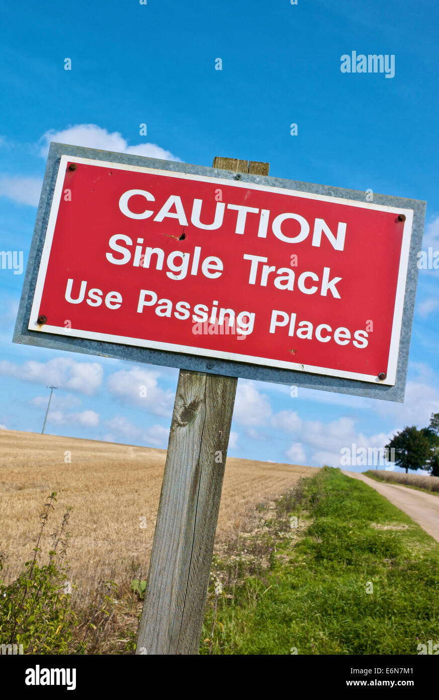 Red sign against blue sky background. Caution Single Track - Use ...