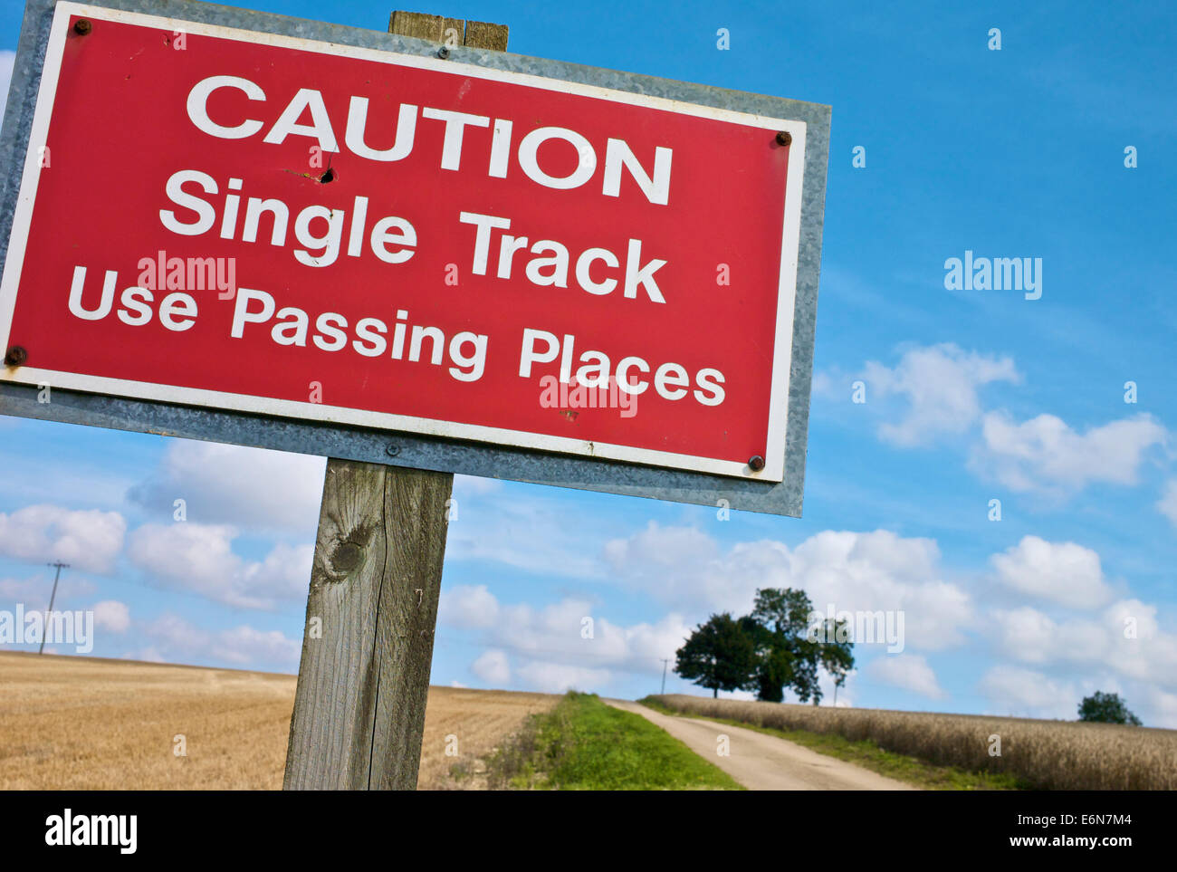 Red sign against blue sky background. Caution Single Track - Use ...