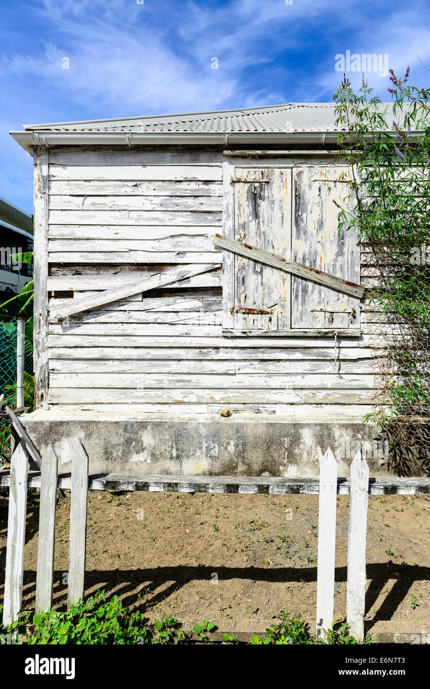 A humble, dilapidated and poor shack behind a broken picket fence in ...