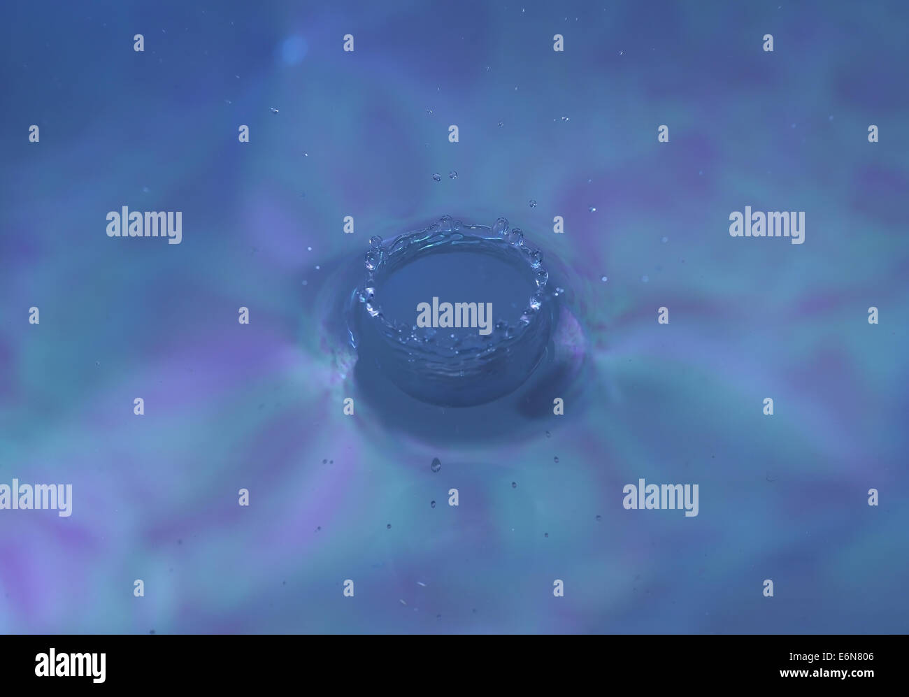 Water splash with a drop of water flying from above Stock Photo - Alamy