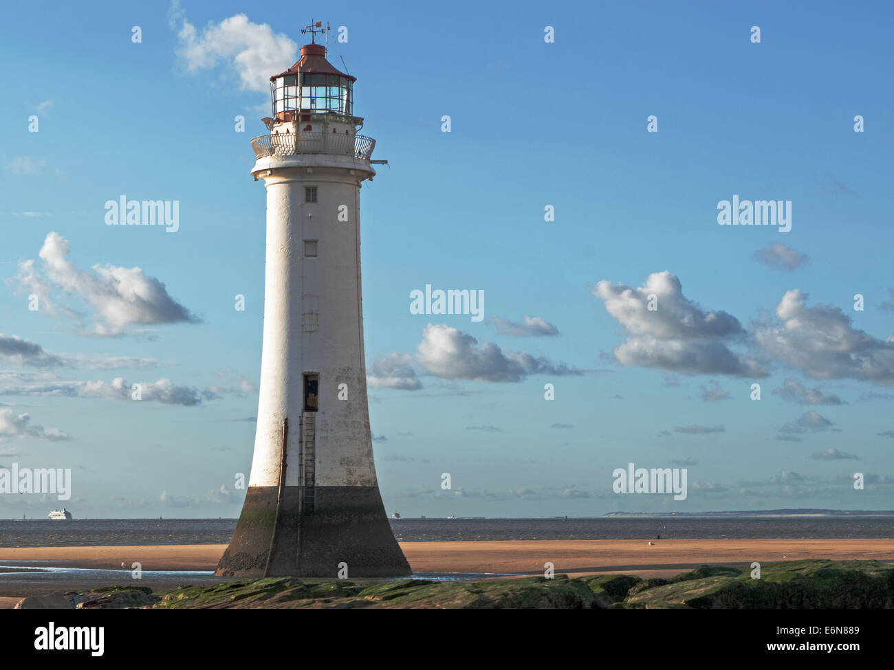 New Brighton Lighthouse, early evening sunlight with a passenger liner ...