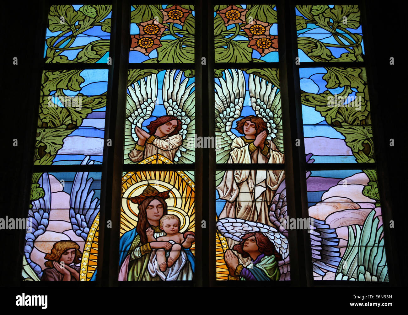 The Virgin Marry surrounded by angels. Stained glass window in Saint ...