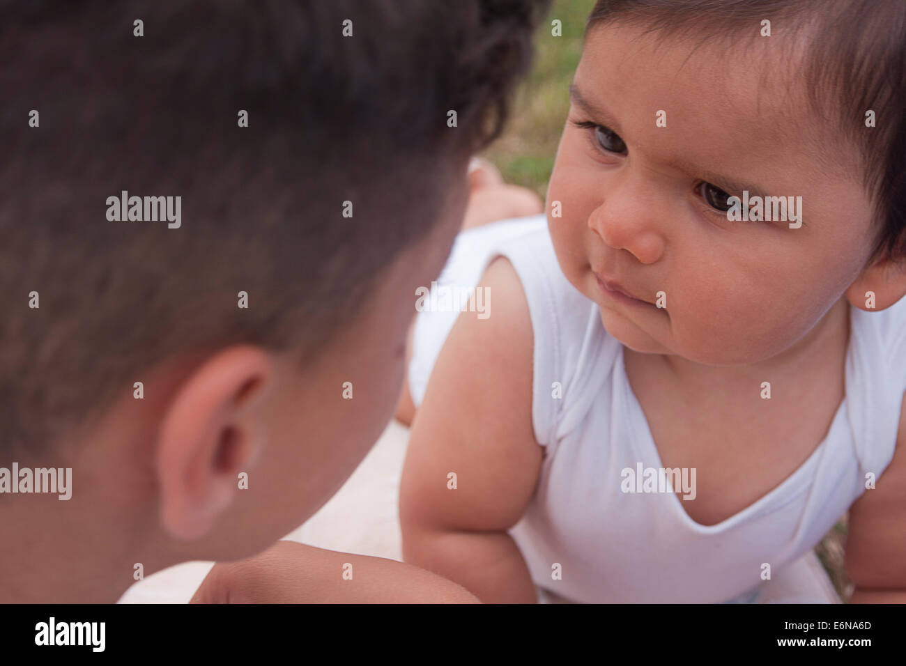 inquisitive baby with sibling Stock Photo - Alamy