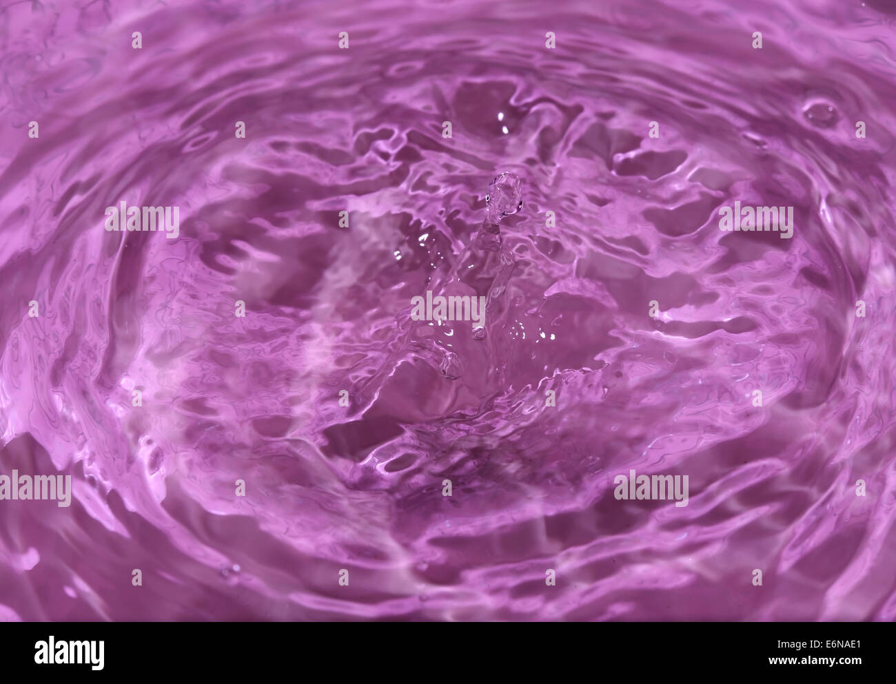 Water splash with a drop of water flying from above Stock Photo - Alamy