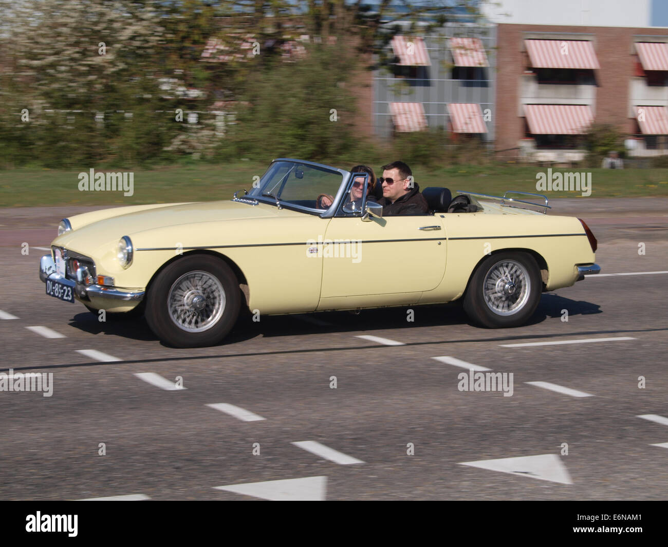 This image features a 1971 MG B sports car with the license plate DL-85 ...