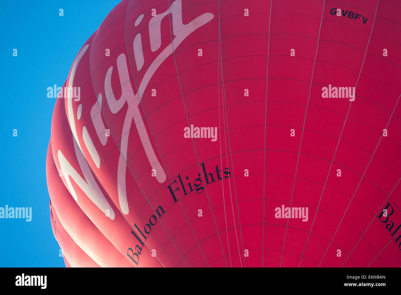 Red Virgin hot air balloon flight with a deep blue late evening sky in ...