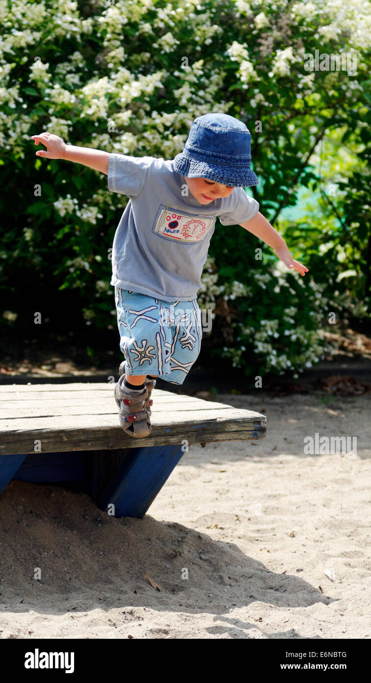 A two year old boy jumping from a park bench Stock Photo - Alamy