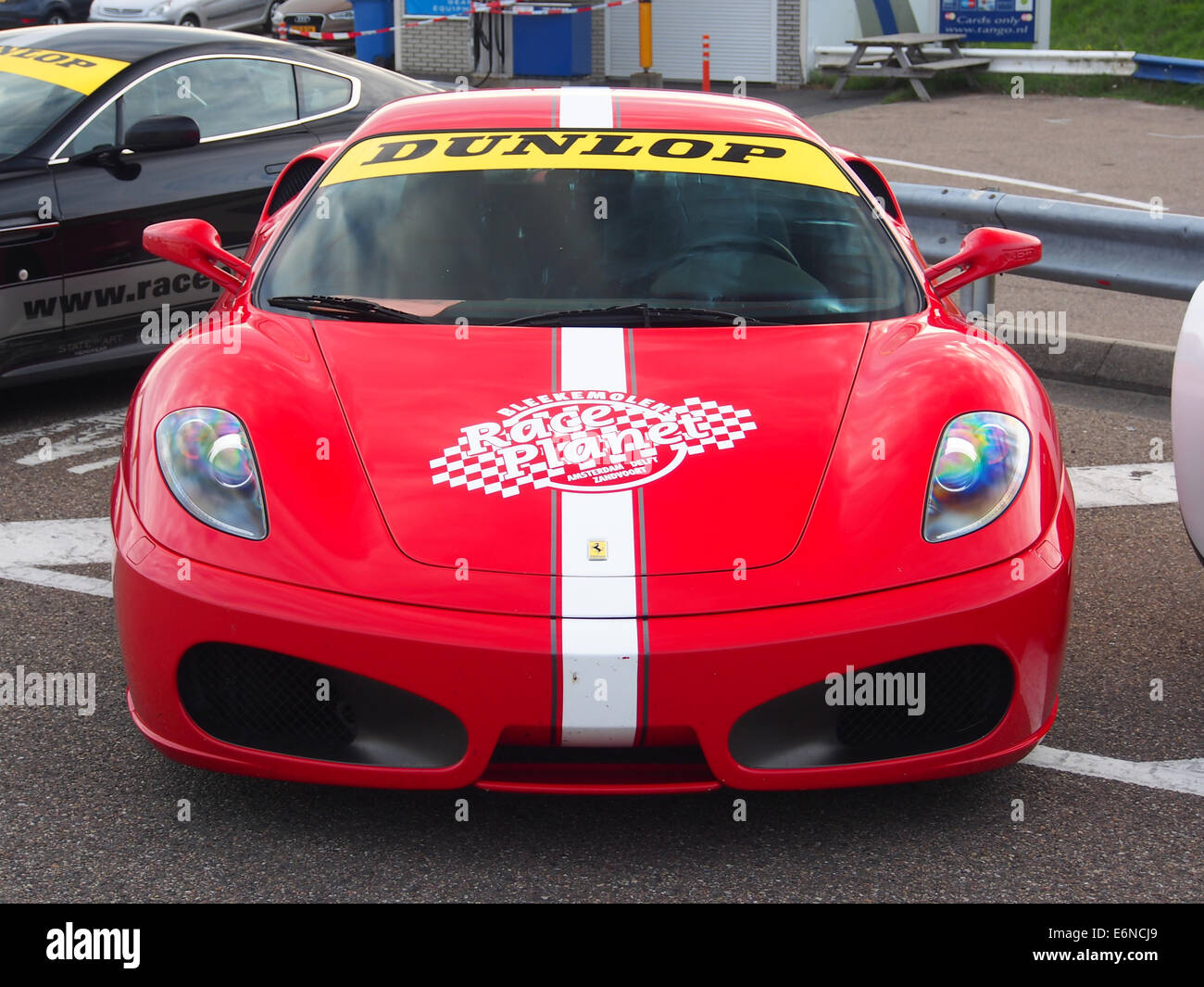 This image features a red Ferrari, a symbol of high-performance sports ...