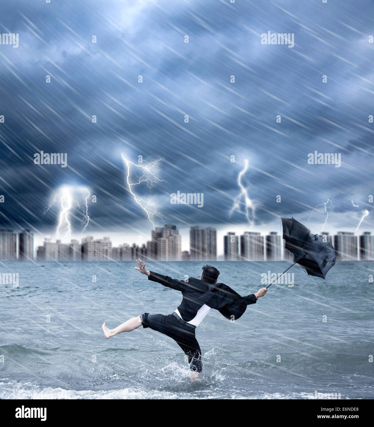businessman holding an umbrella with thundershower Stock Photo - Alamy