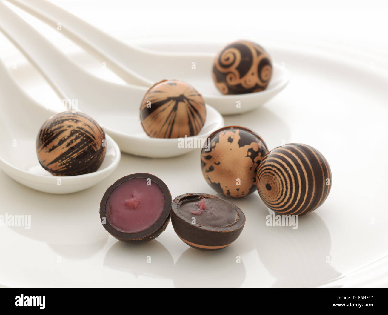 hand made chocolates with white china spoons and plate Stock Photo - Alamy