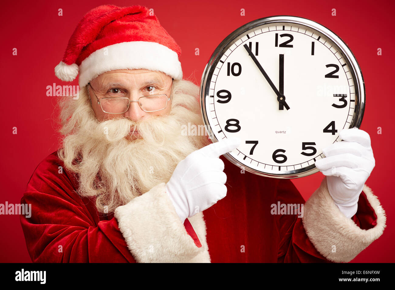 Happy santa pointing clock showing hi-res stock photography and images ...