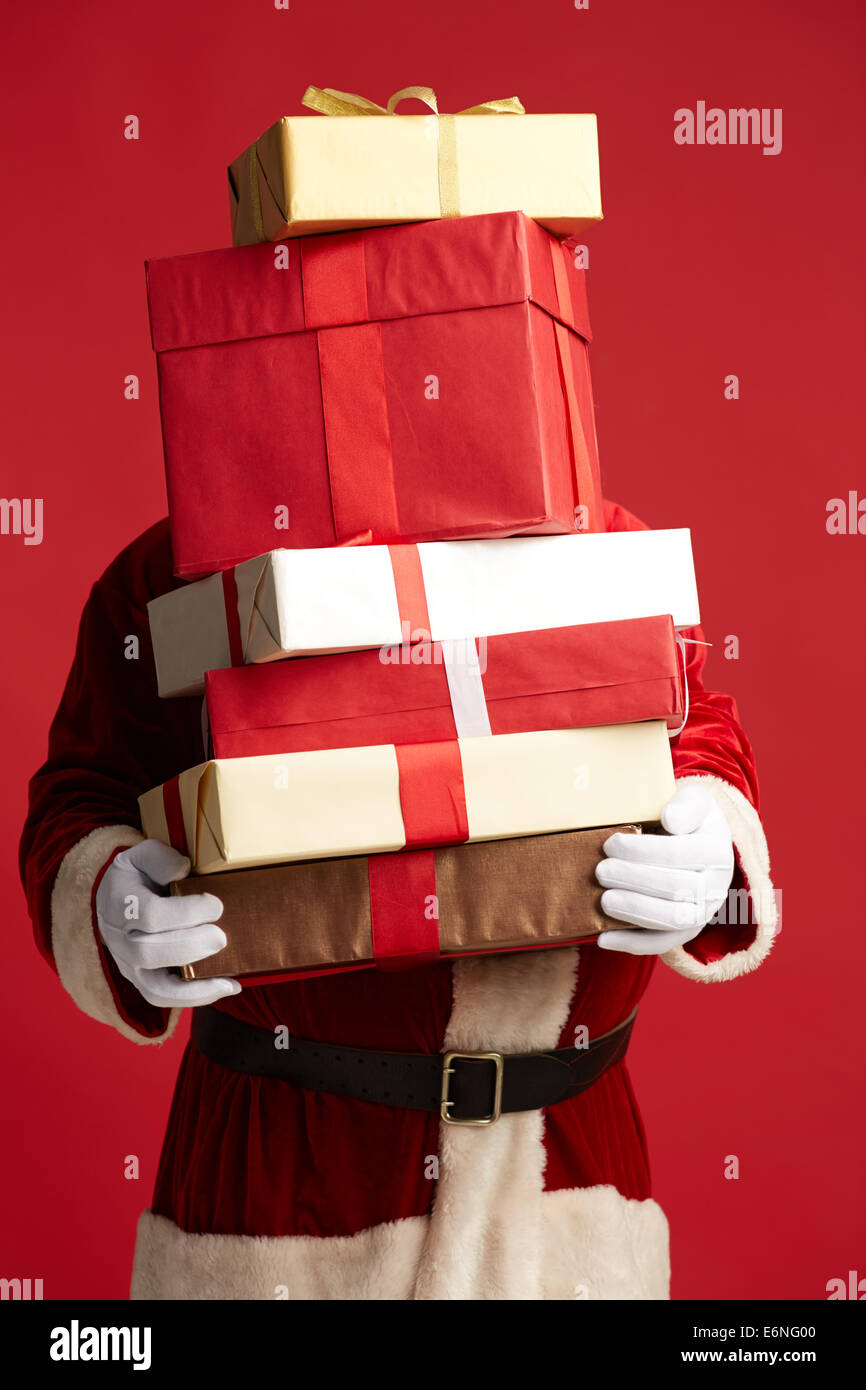 Santa Claus holding pile of giftboxes in isolation Stock Photo - Alamy