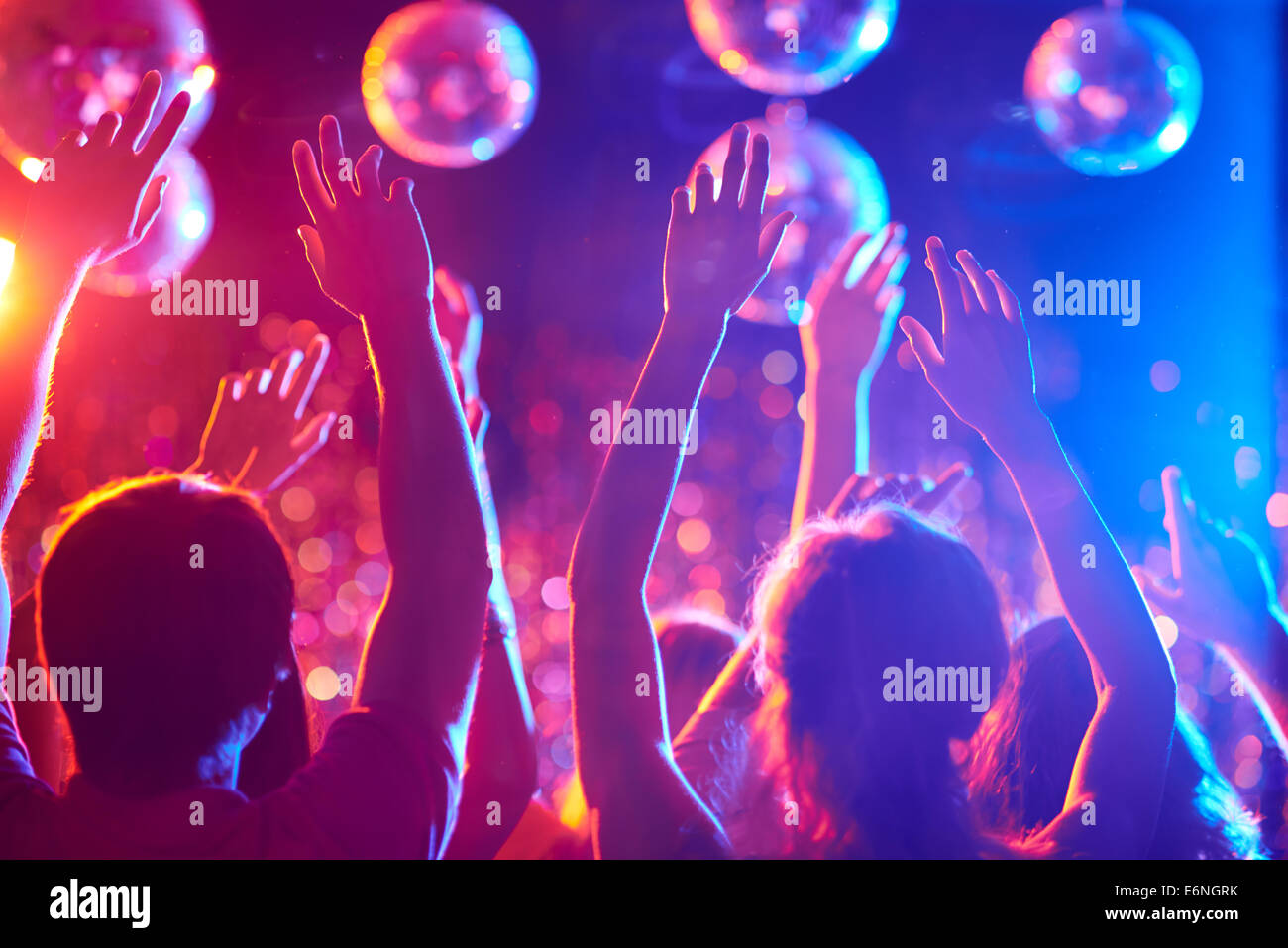Arms of friends dancing in night club Stock Photo - Alamy